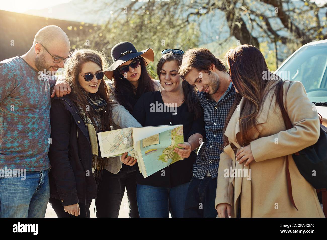 Friends are the best traveling buddies. a group of friends looking at a ...