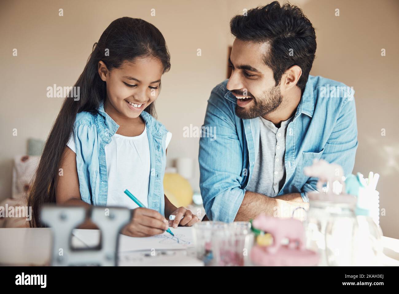 Encouraging creative expression. a cute young girl and her father ...