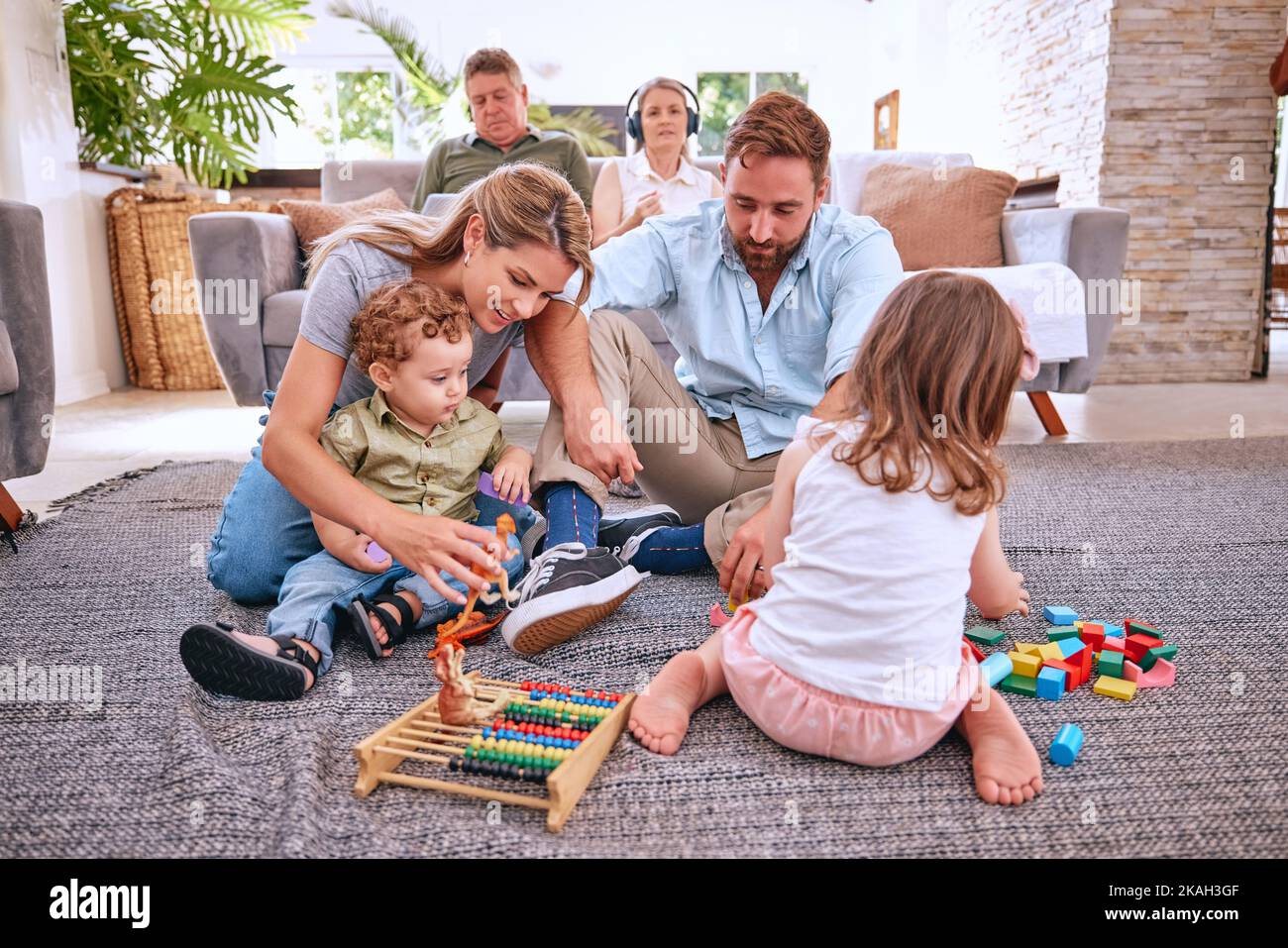 Family, toys and kids play in living room home, having fun and bonding ...
