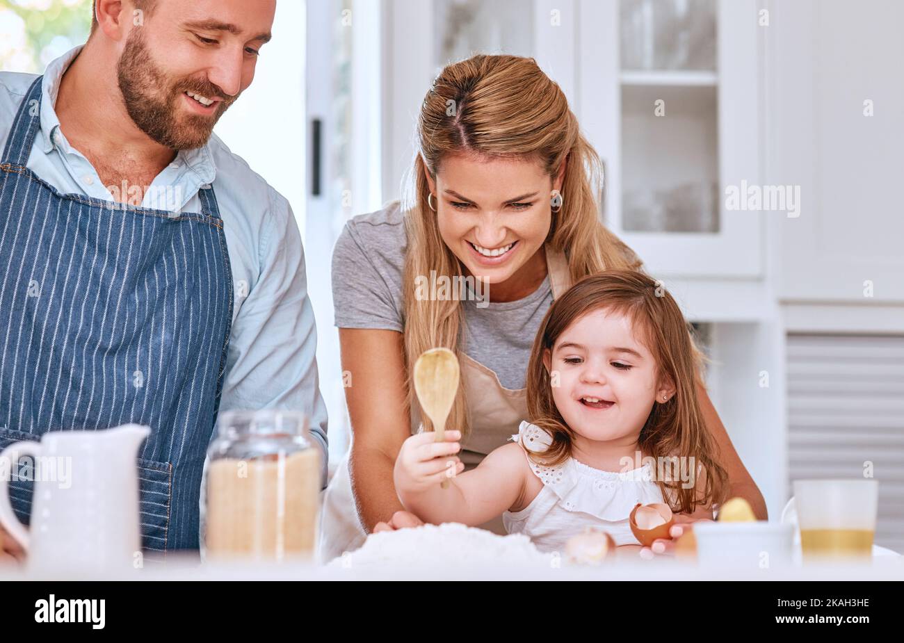 Cooking, family and bakery food in kitchen with child learning, helping ...