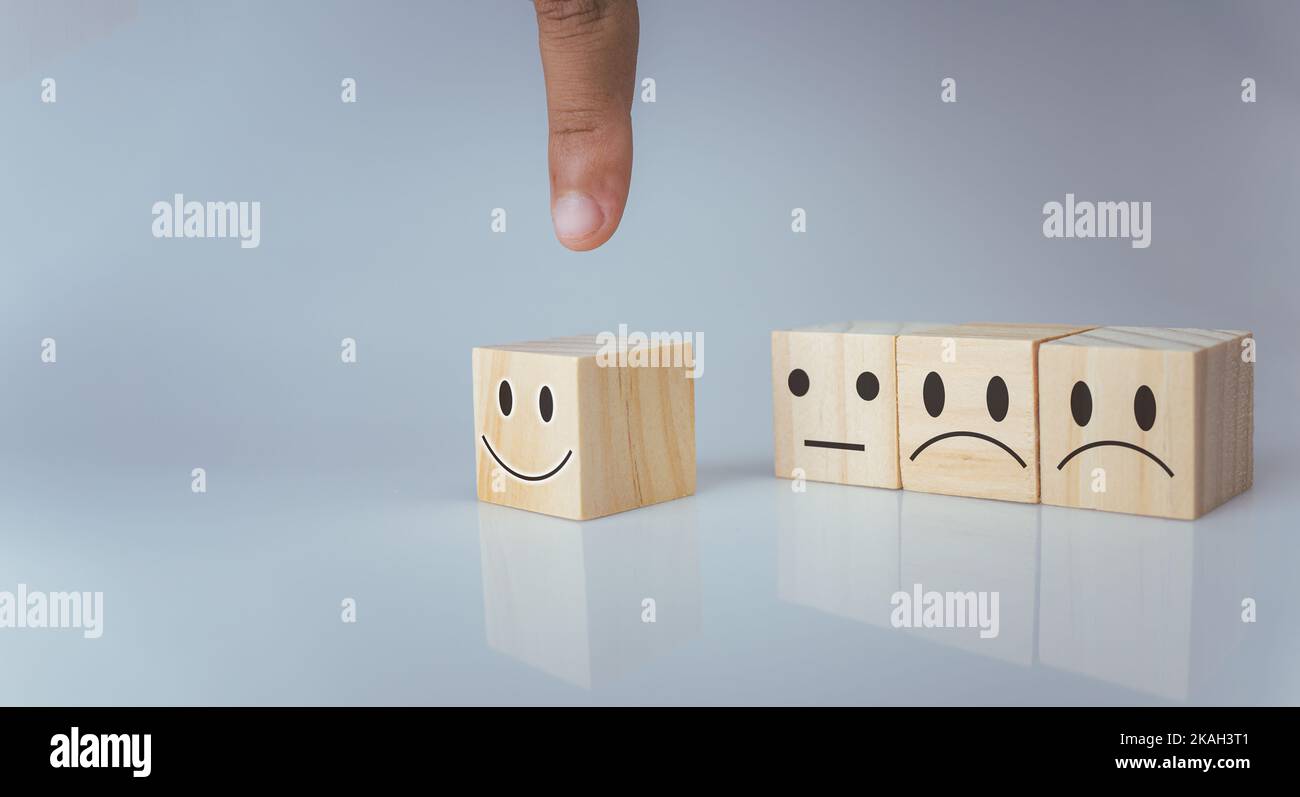 Hand choosing happy smile icon. represents feedback rating and positive ...