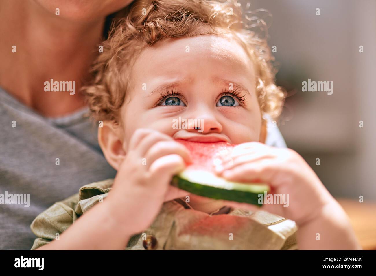 Baby, water melon and cute with an infant boy child eating fruit with ...