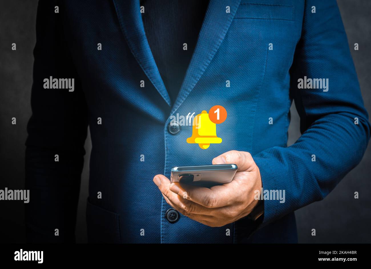 push notification. Businessman holding smartphone with virtual yellow ...