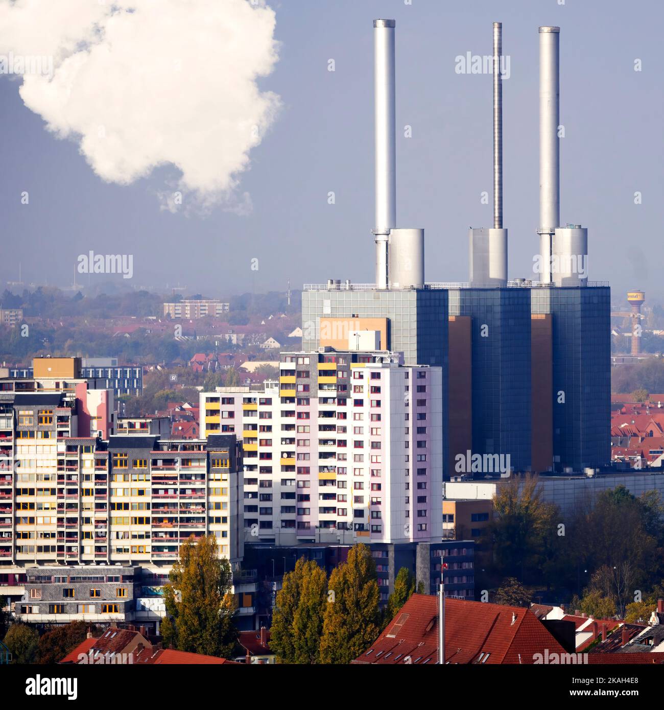 Towers and chimneys of a huge combined heat and power plant behind ...