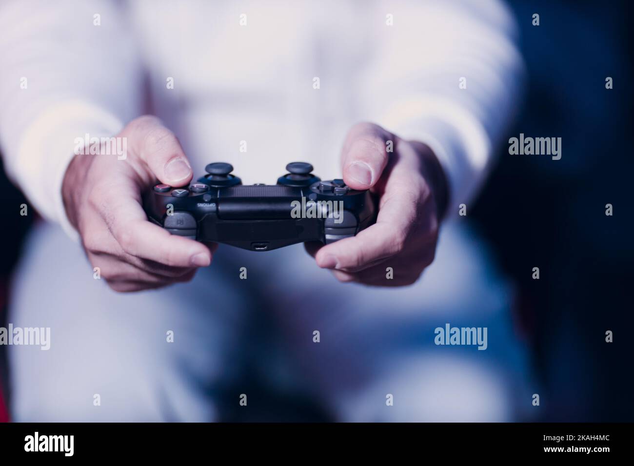 Guy young adult man gamer playing video game on game console hold ...