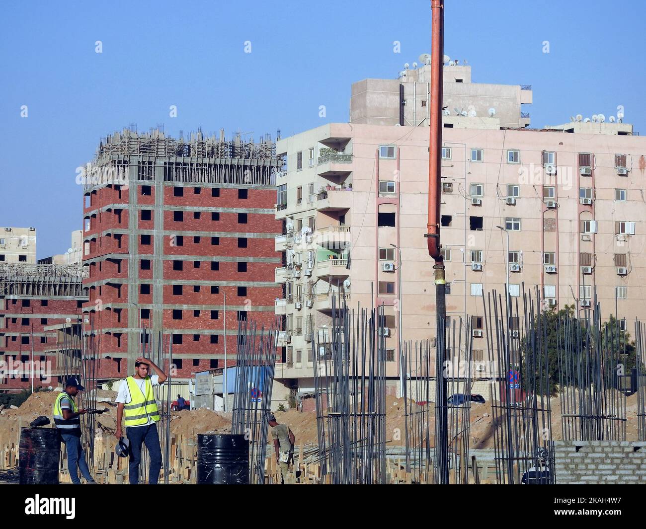 Cairo, Egypt, October 3 2022: A truck-mounted concrete boom pump at the side of the road pouring ...