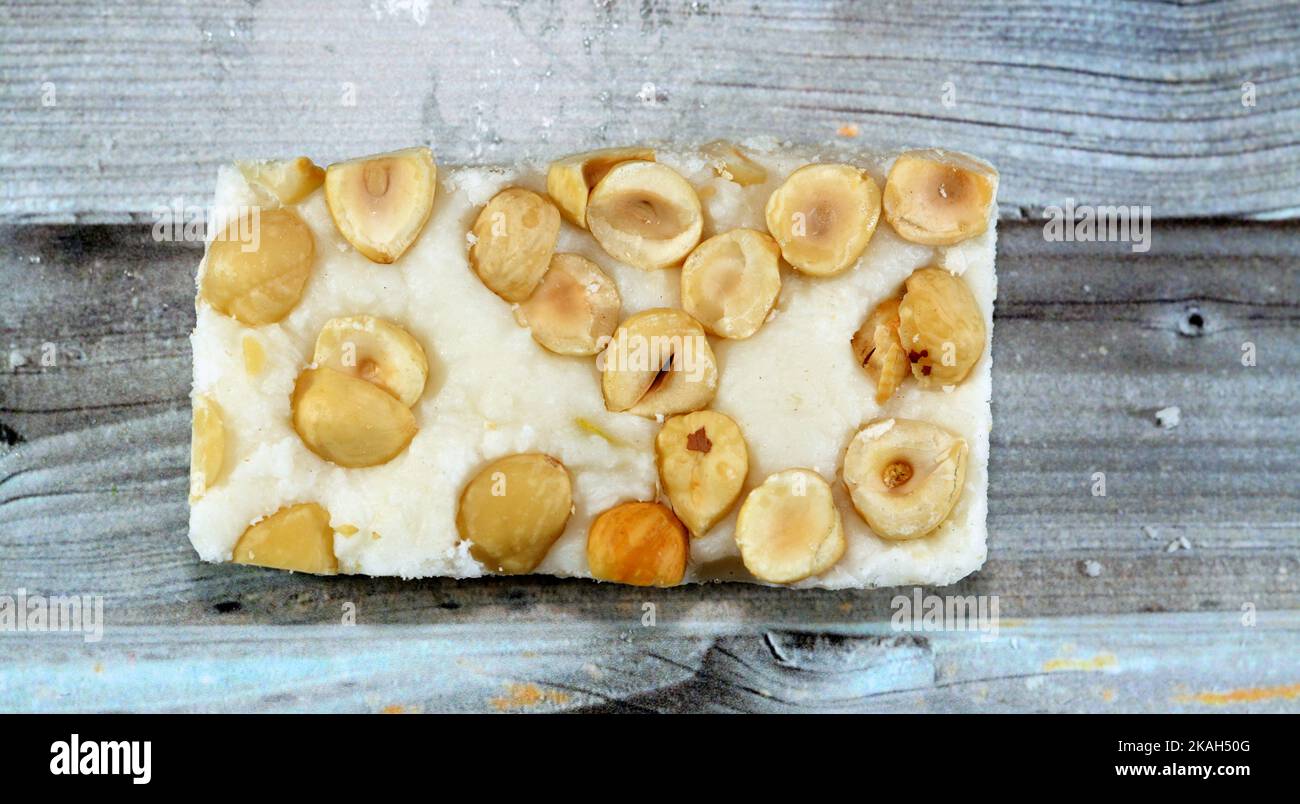 Soft coconut candy covered with hazelnuts, Egyptian cultural desserts ...