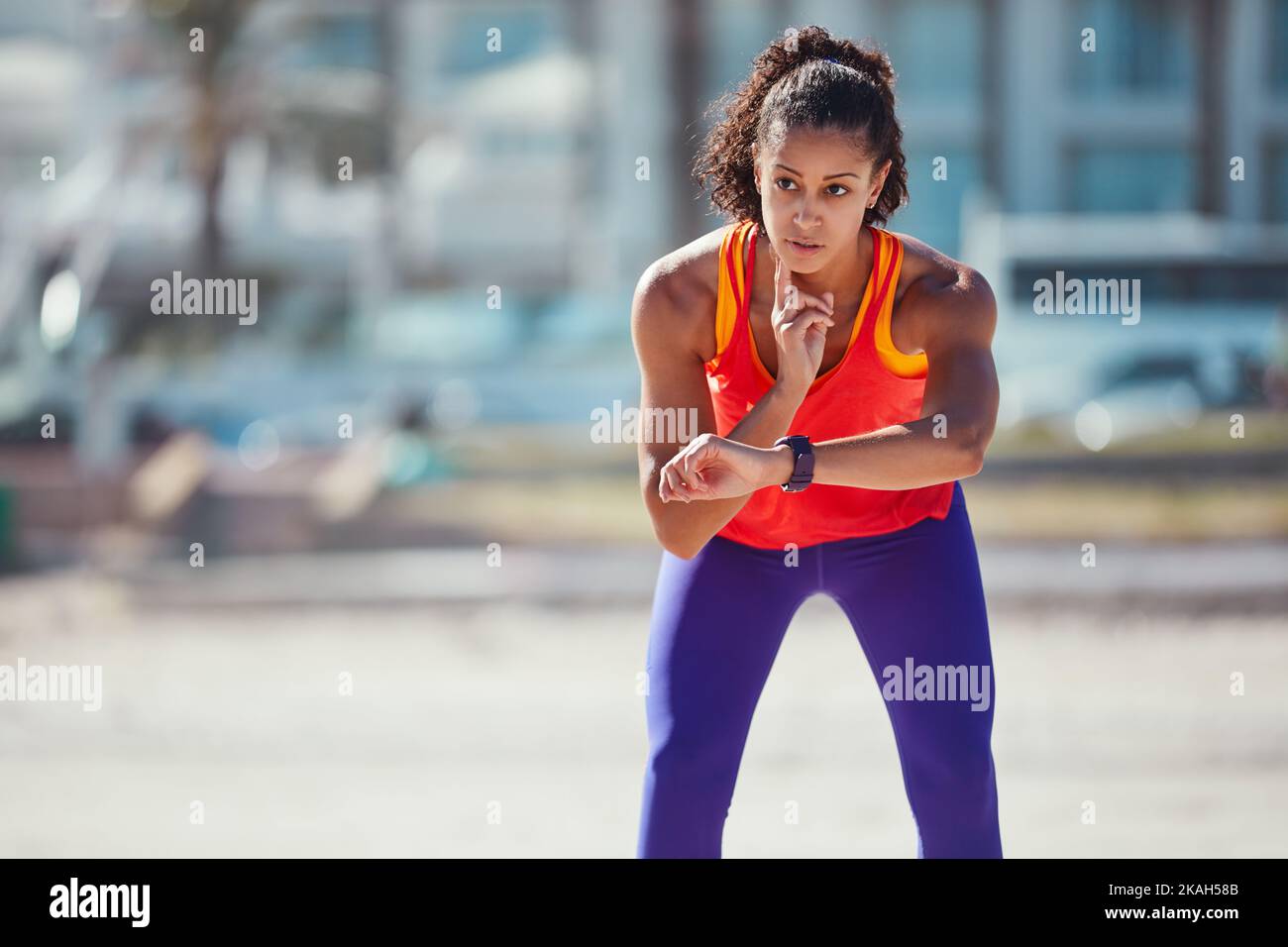 Keep track of your heart rate during your exercise. a sporty young ...