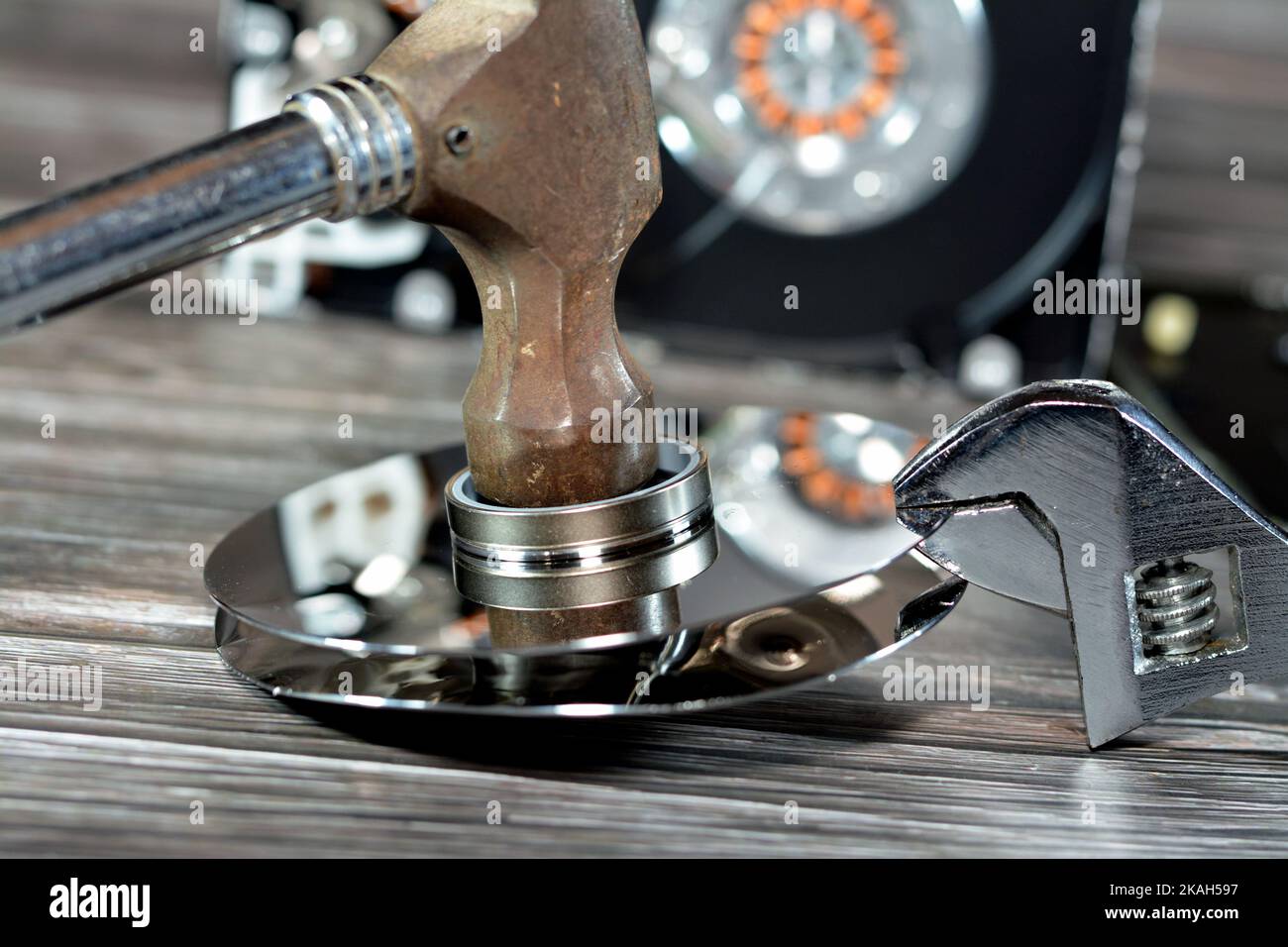 Spanner wrench and steel hammer with HDD platters, hard disk drive ...