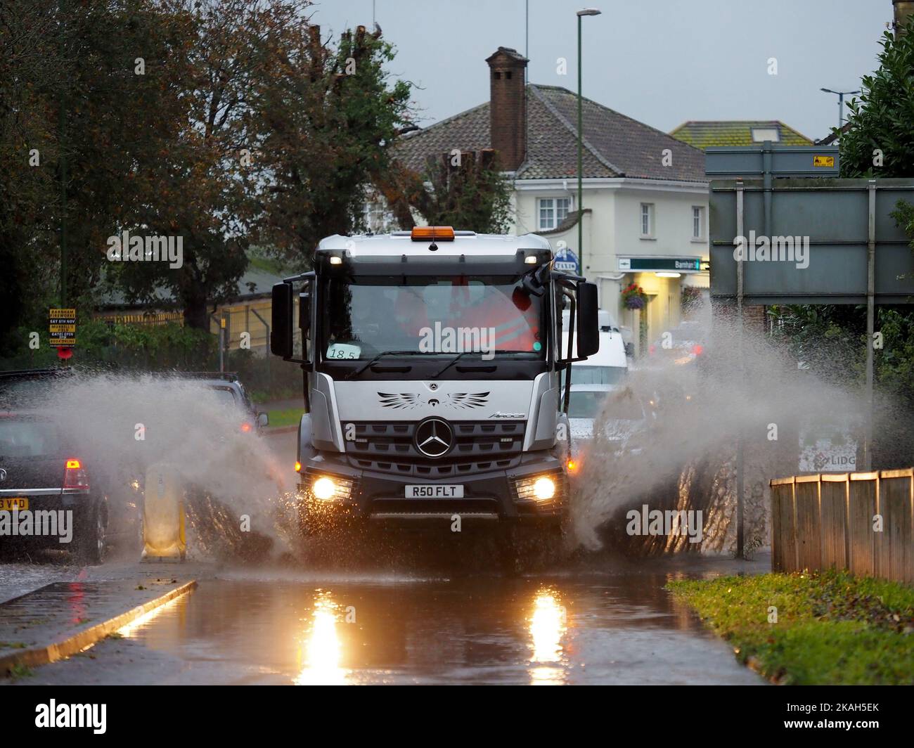 Drivers struggle through a flooded road in Barnham, West Sussex ...