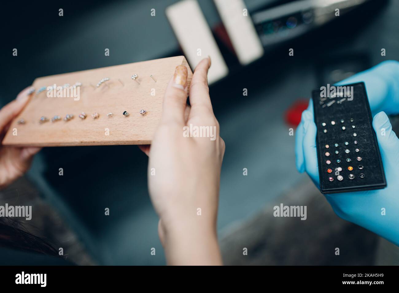 Young woman doing ear piercing at beauty studio salon Stock Photo - Alamy