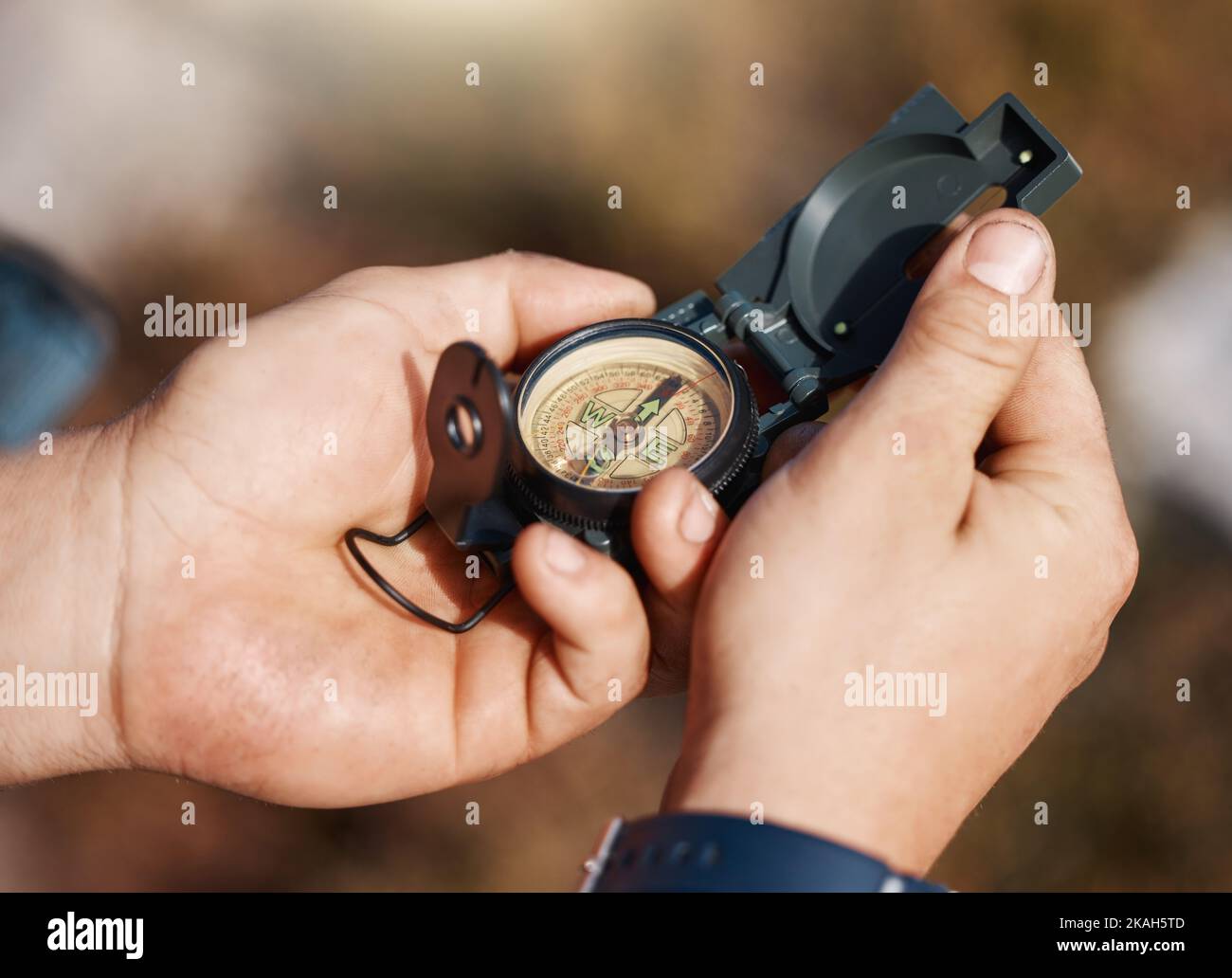 Hands, compass and travel for direction, map or location in adventure ...