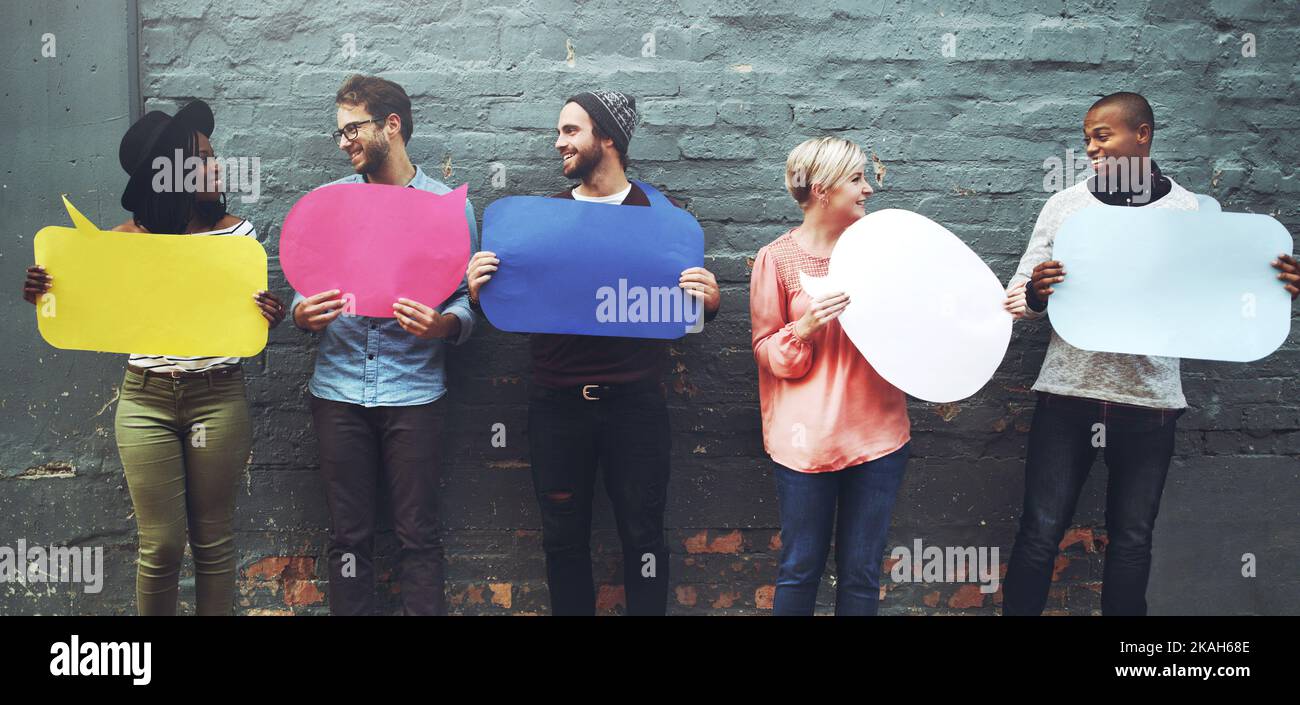 Time to speak up. a diverse group of people holding up speech bubbles ...