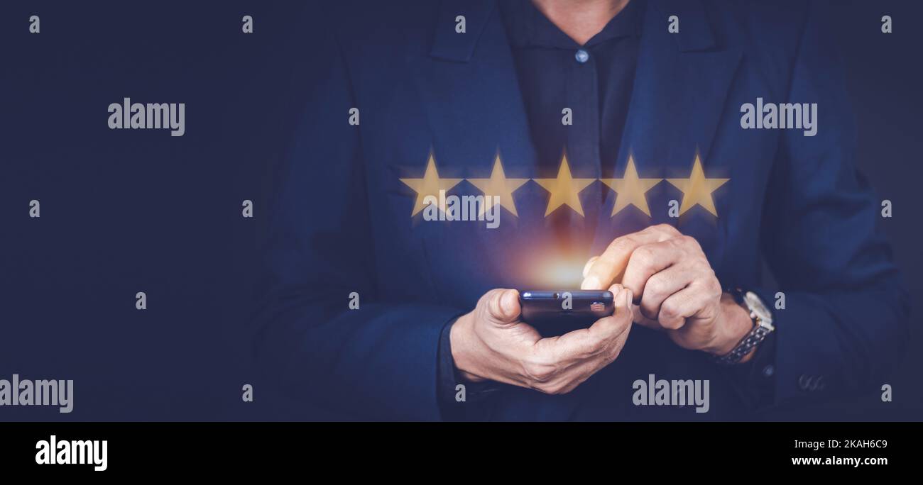 Man hand using smart phone and give five star symbol to increase rating ...