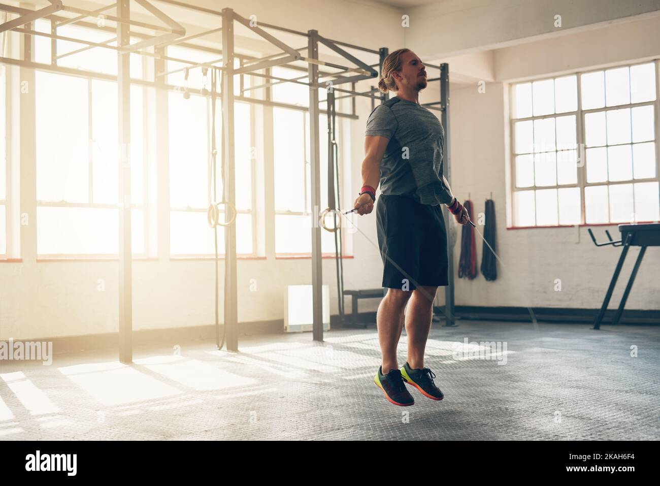 The burn is his motivation. a muscular young man training with a ...