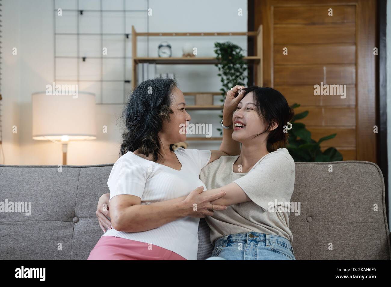 smiling grownup daughter hugging older mother. two generations concept ...