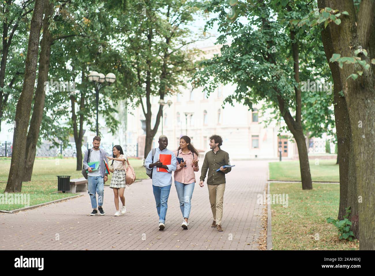 group multicultural students walking together in park Stock Photo - Alamy