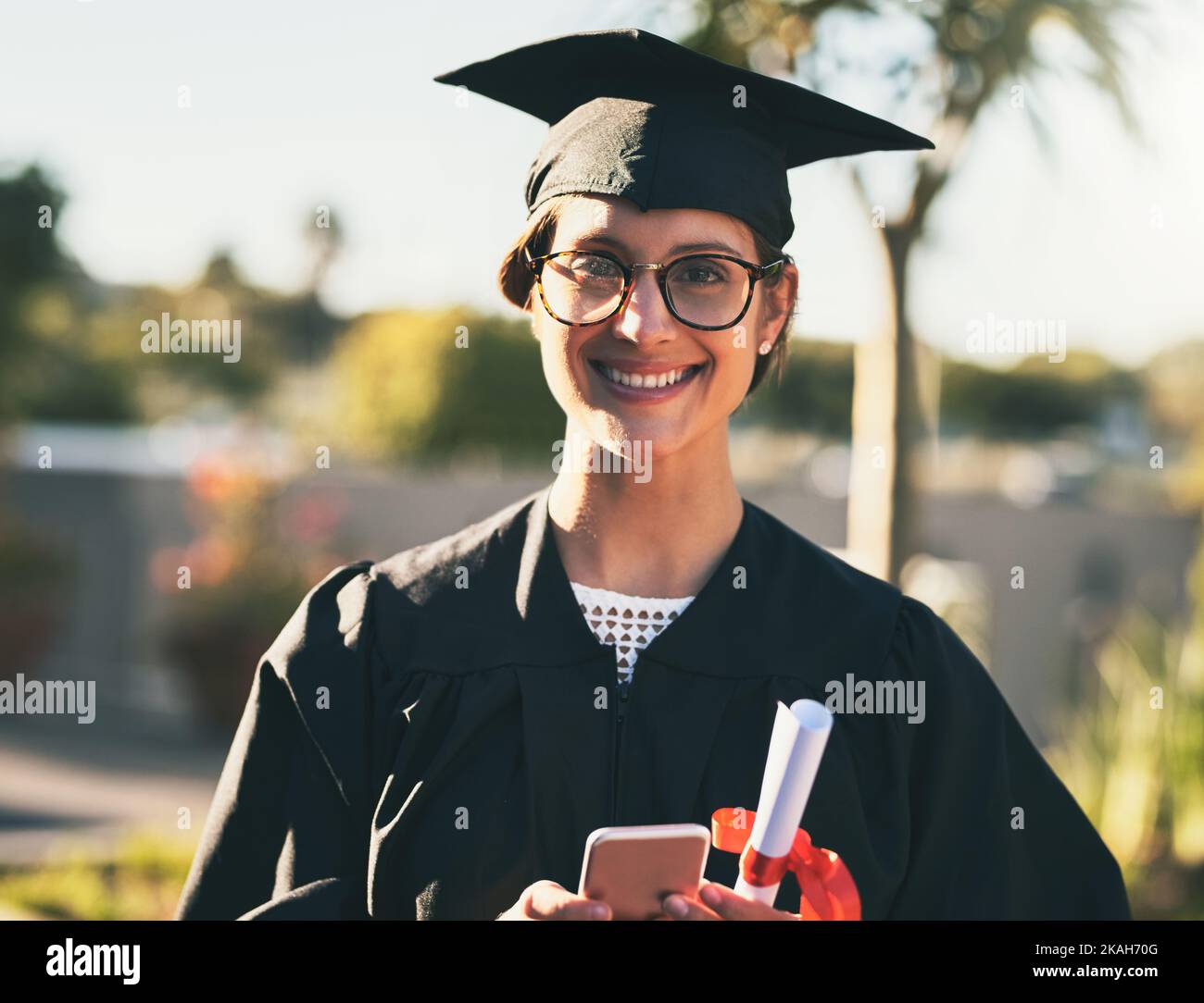 I worked hard to see this day. a young woman using a mobile phone on ...