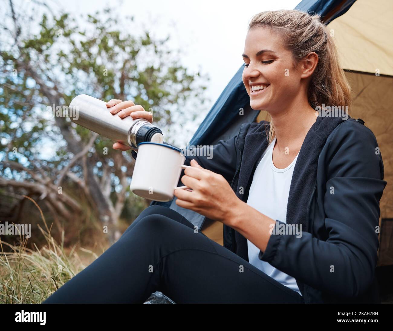 Camping, coffee and woman in nature by tent on vacation, holiday or ...