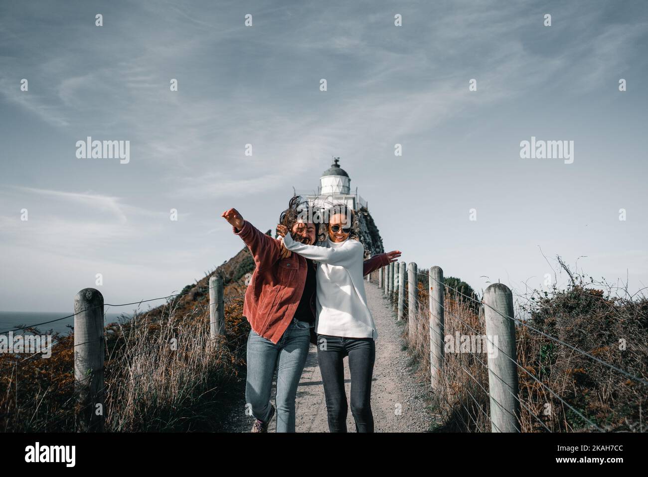 two caucasian girls jumping hugging having fun happy smiling running ...