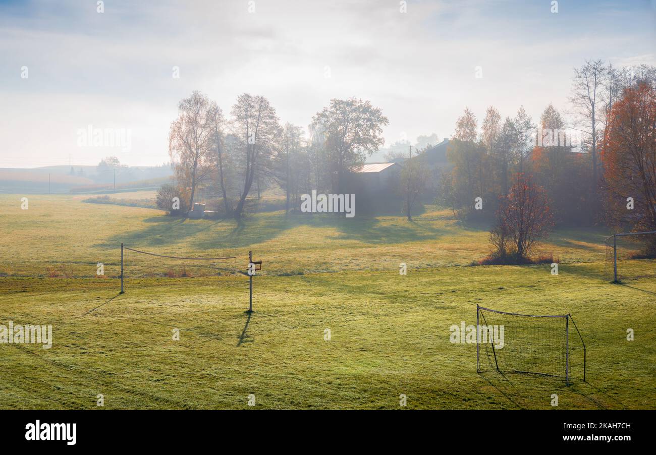 The green grass field of football field in the fog hi-res stock ...