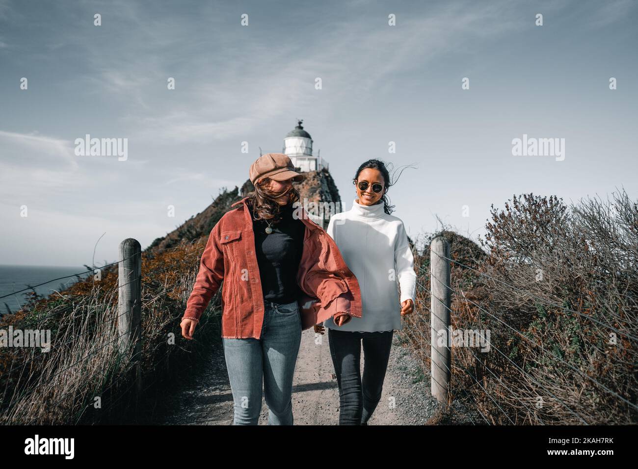 two happy caucasian girls having fun running towards the camera up the ...