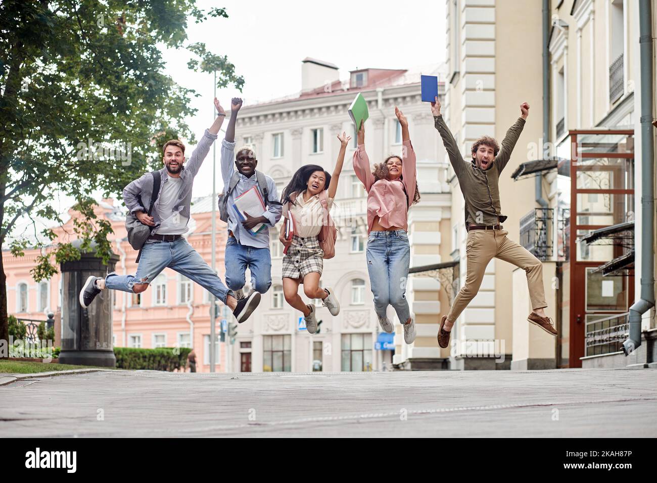 happy group of students having fun on a city street Stock Photo - Alamy