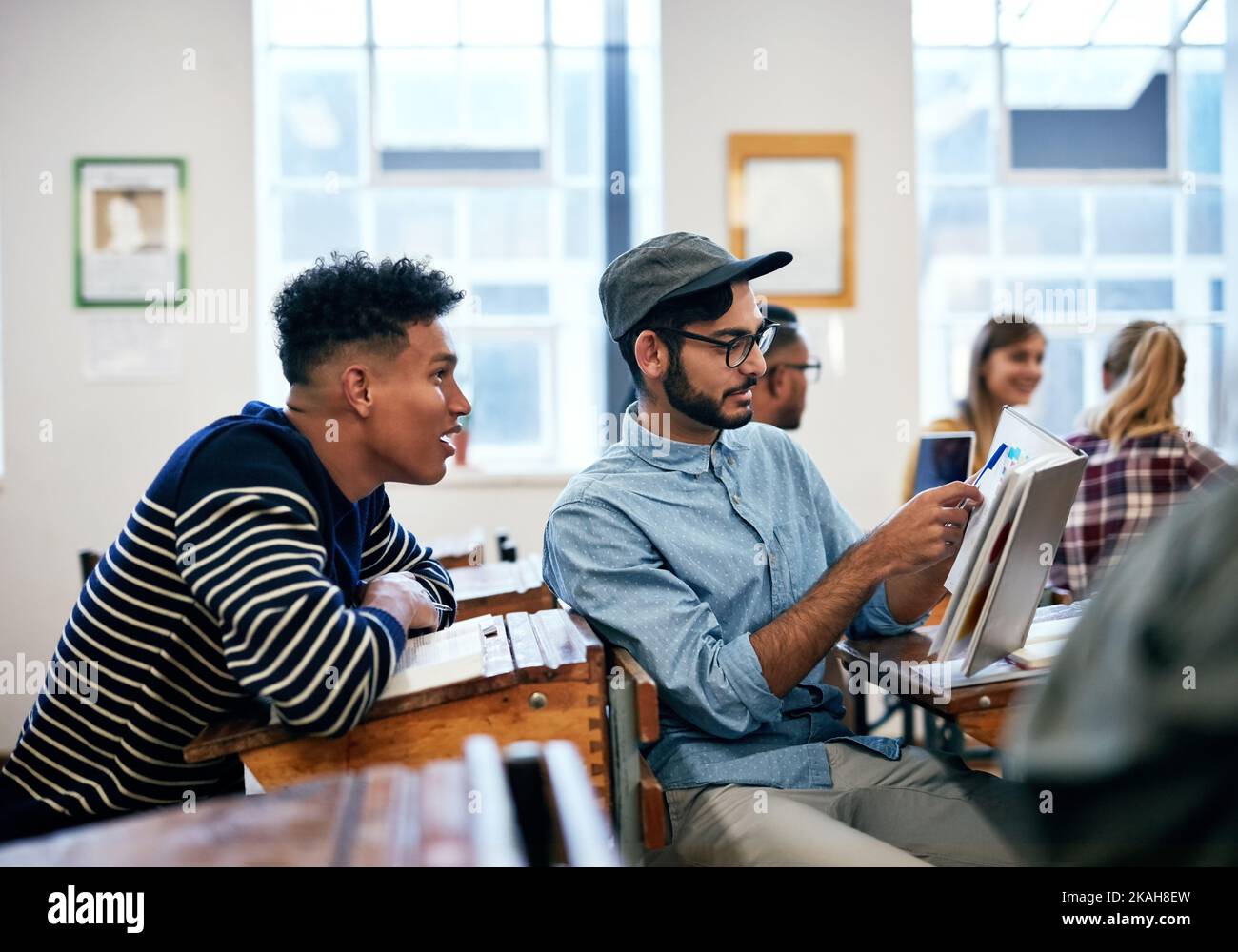Students helping each other in class hi-res stock photography and ...