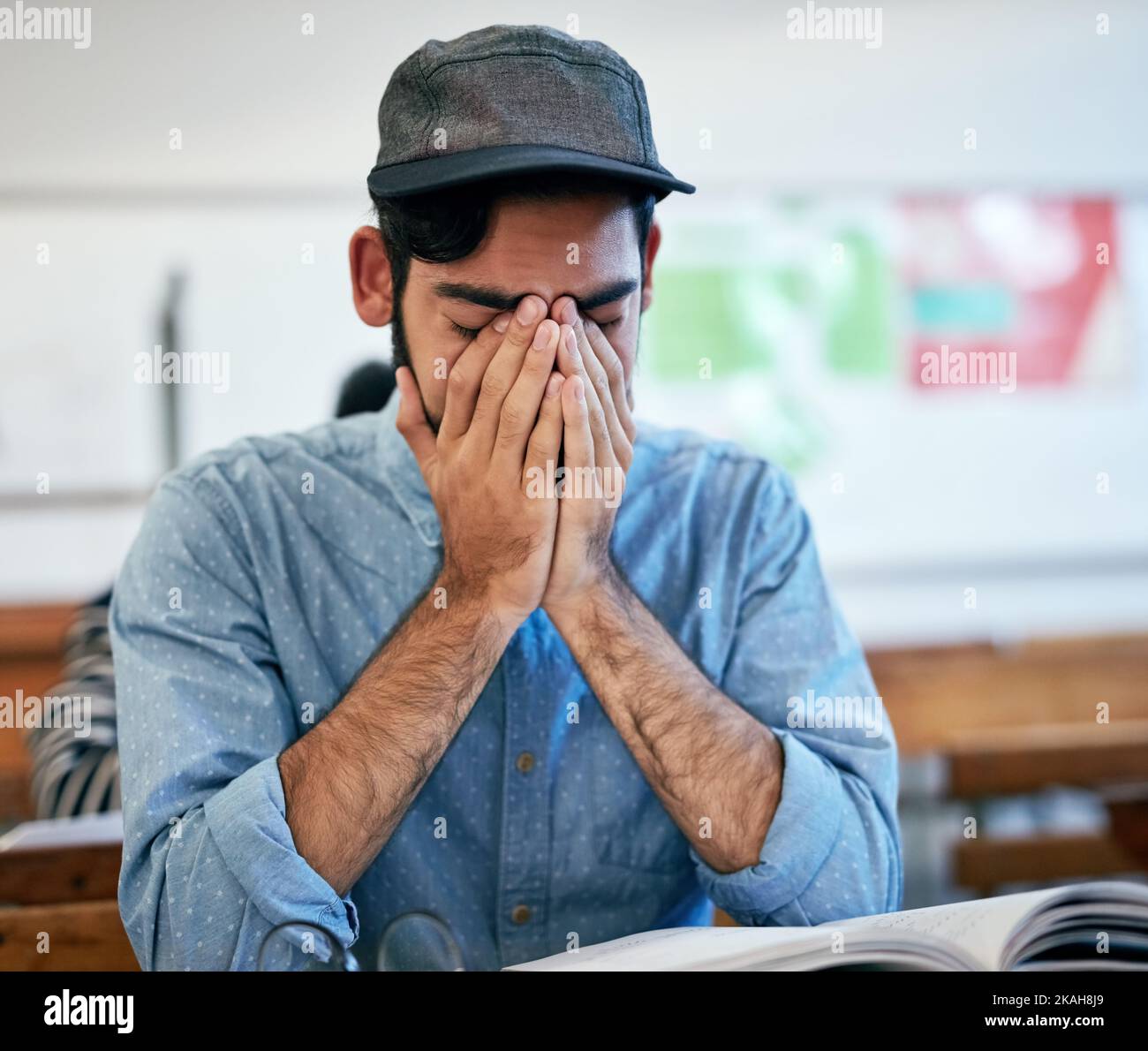 Oh no, I shouldve studied. an university student covering his face in ...