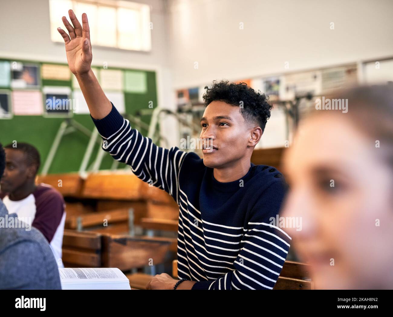 Hes confident he has the answer. an university student hand raised in ...