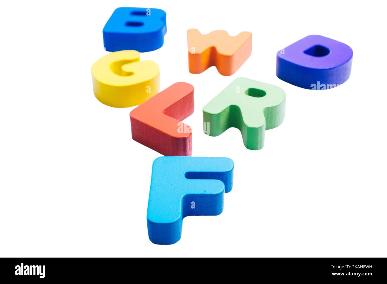 Colored wooden letters of the English alphabet on a white background ...