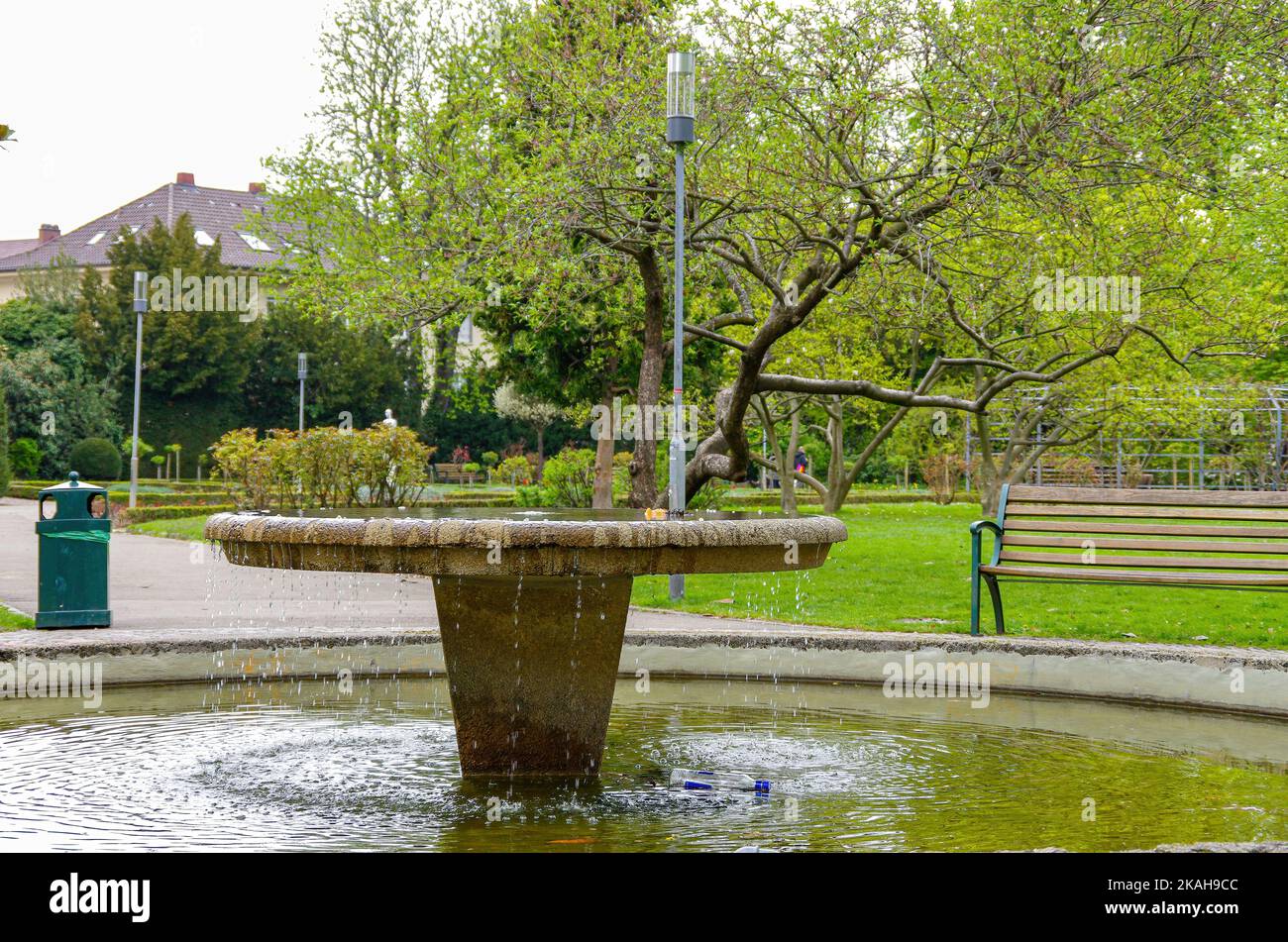 Disfigured spring fountain in the city park of Freiburg im Breisgau ...