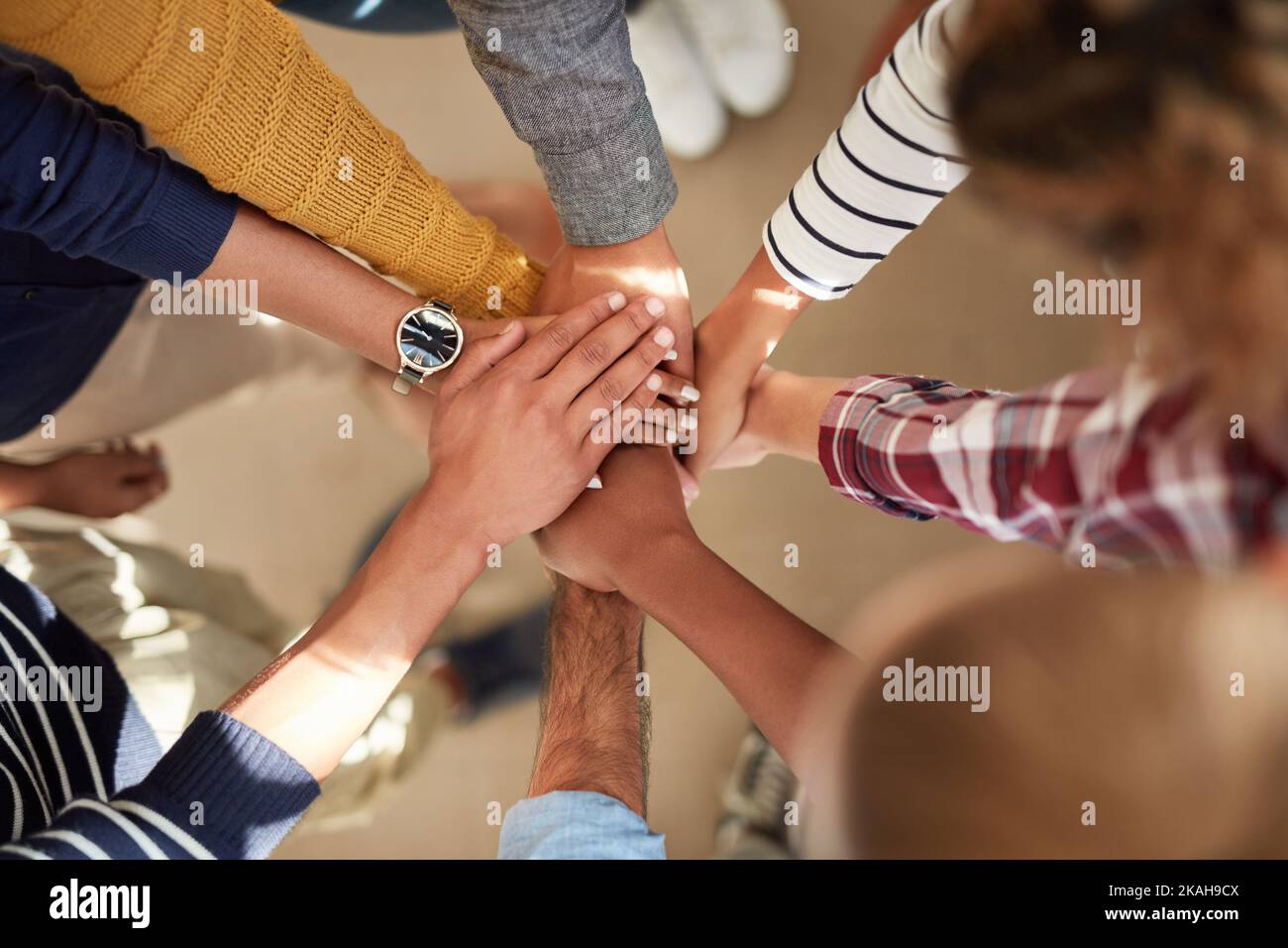 Bring it in. High angle shot of a group of people joining their hands ...