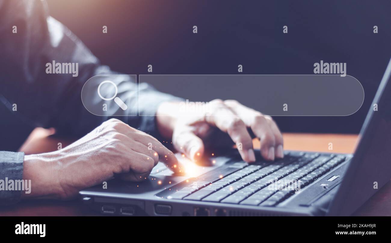 Data Search Technology Search Engine Optimization. man's hands are using a computer notebook to ...