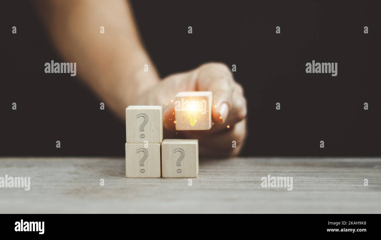 Concept of problem solving, creativity, idea or innovation. Male hand places a wooden cube with ...