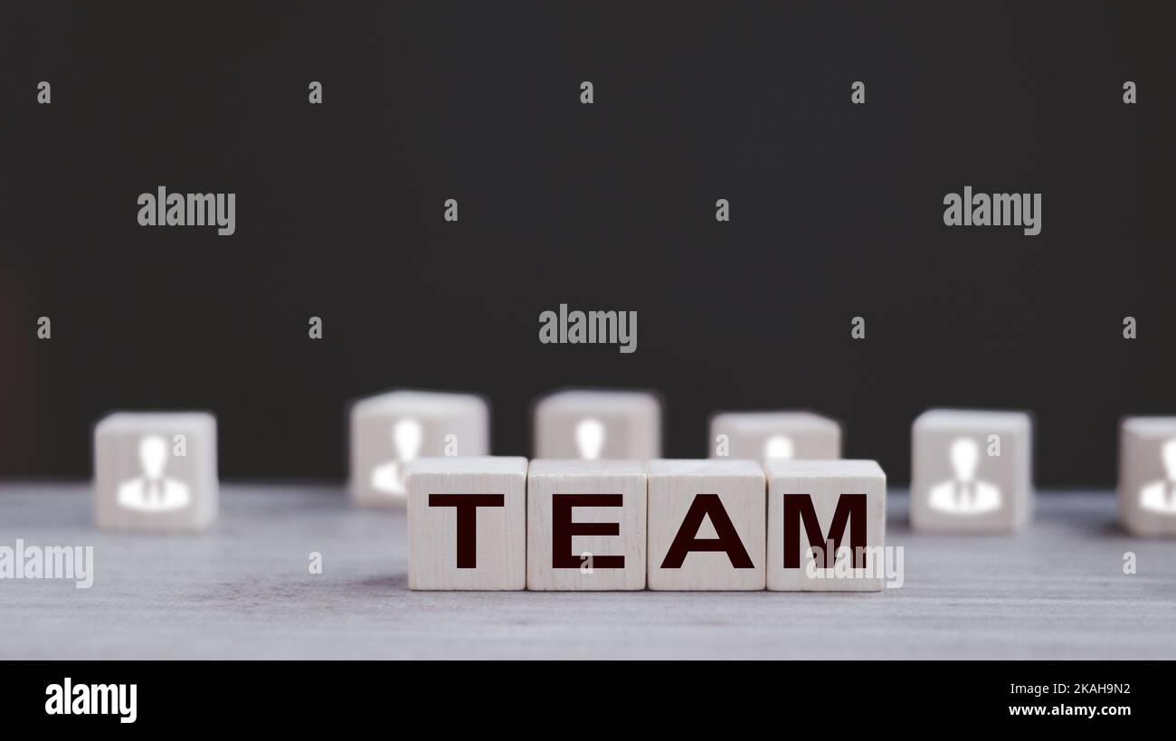 Word team on wooden block, relationship of collaboration and leadership ...