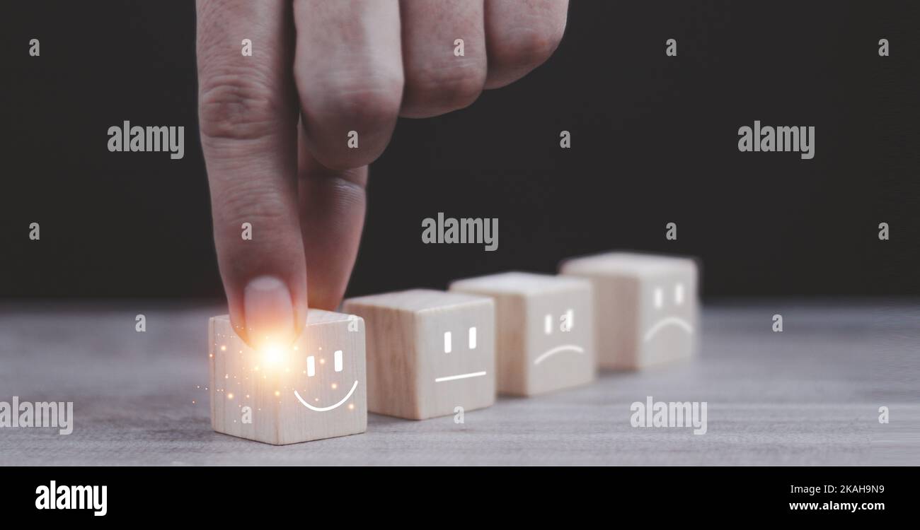 Close up customer hand choose smiley face and blurred sad face icon on ...