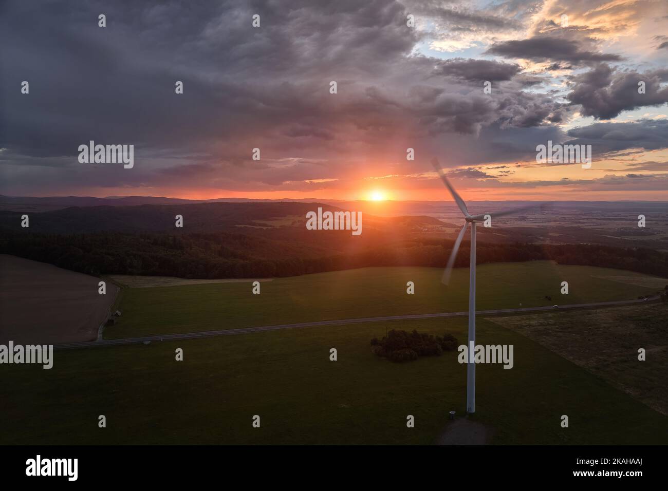 Aerial view of wind power plant in full load, illuminated with dramatic ...