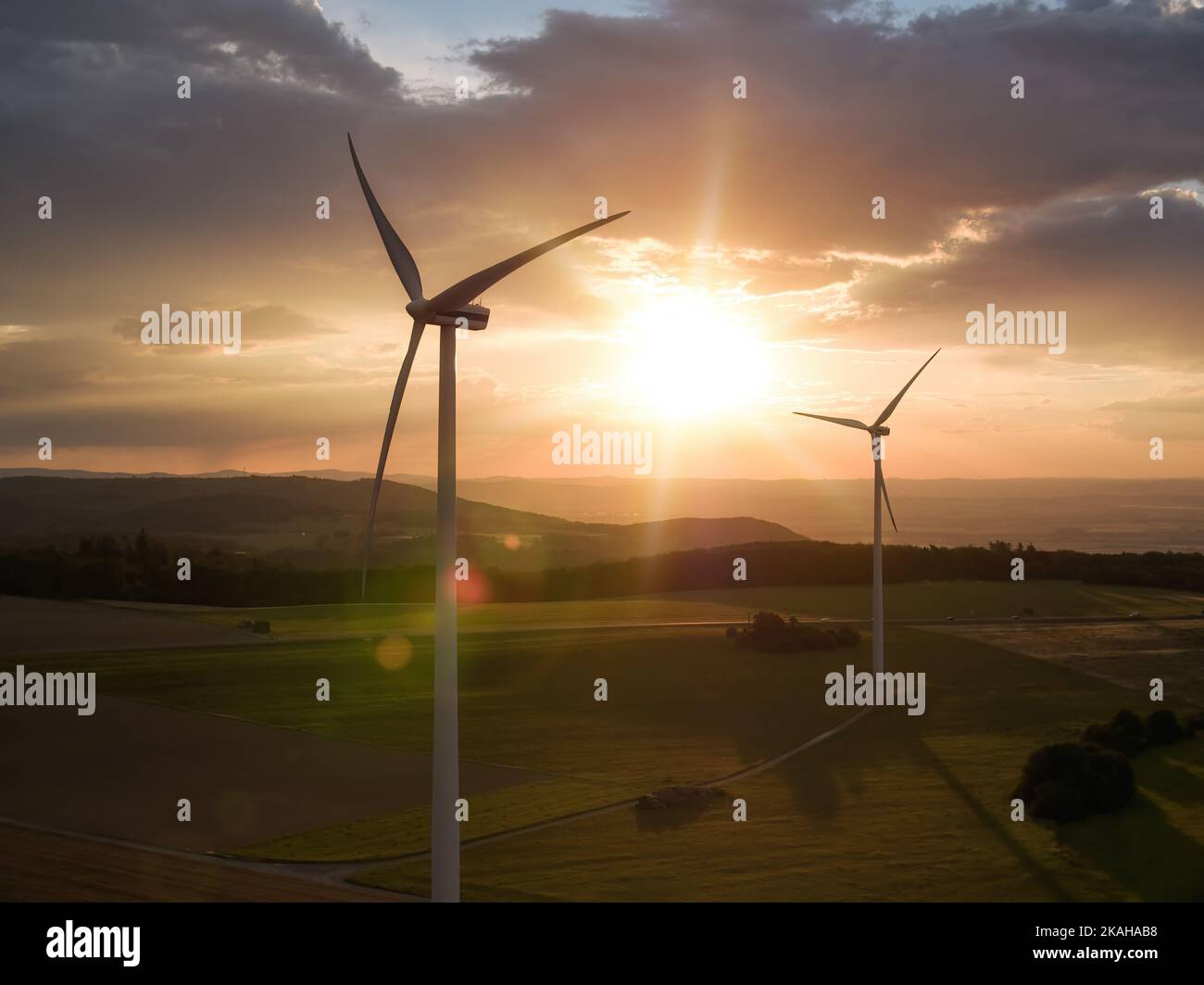Aerial view of wind power plant in full load, illuminated with dramatic ...