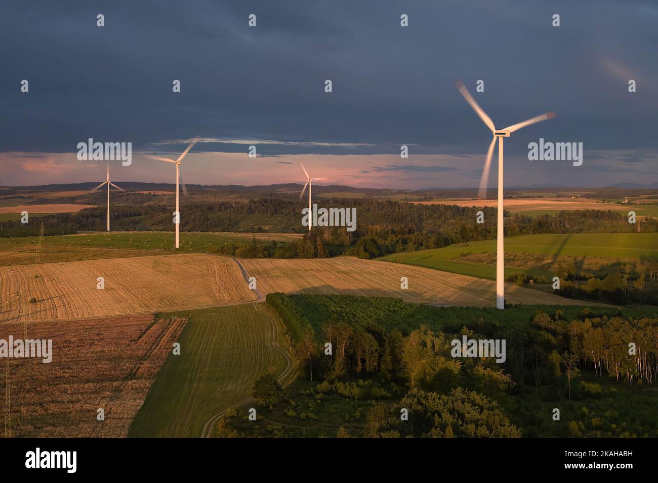 Aerial view of wind power plant in full load, illuminated with dramatic ...