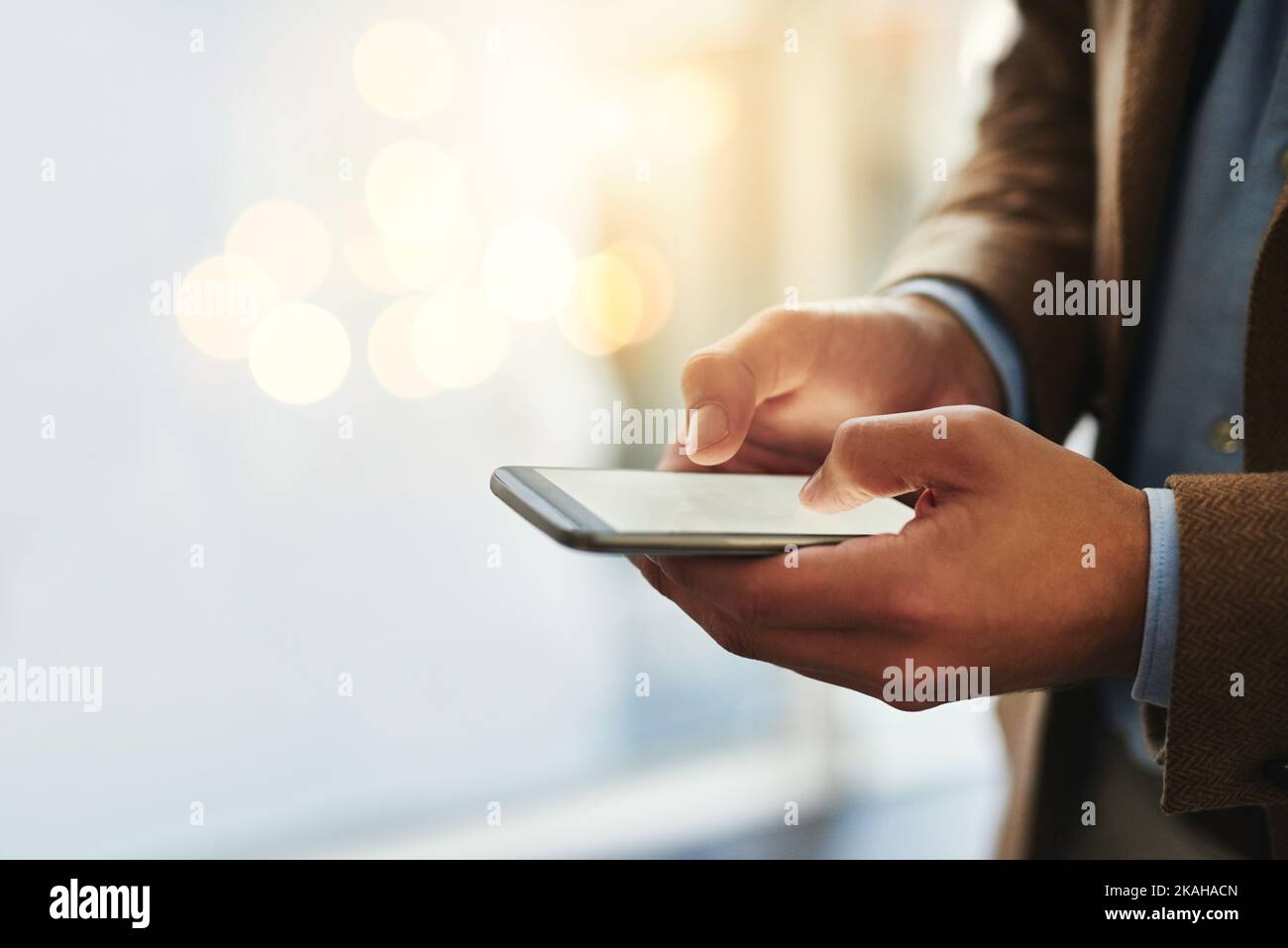 Working remotely. an unrecognizable businessman using a mobile phone ...