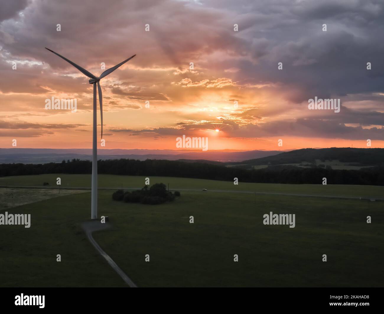 Aerial view of wind power plant in full load, illuminated with dramatic ...
