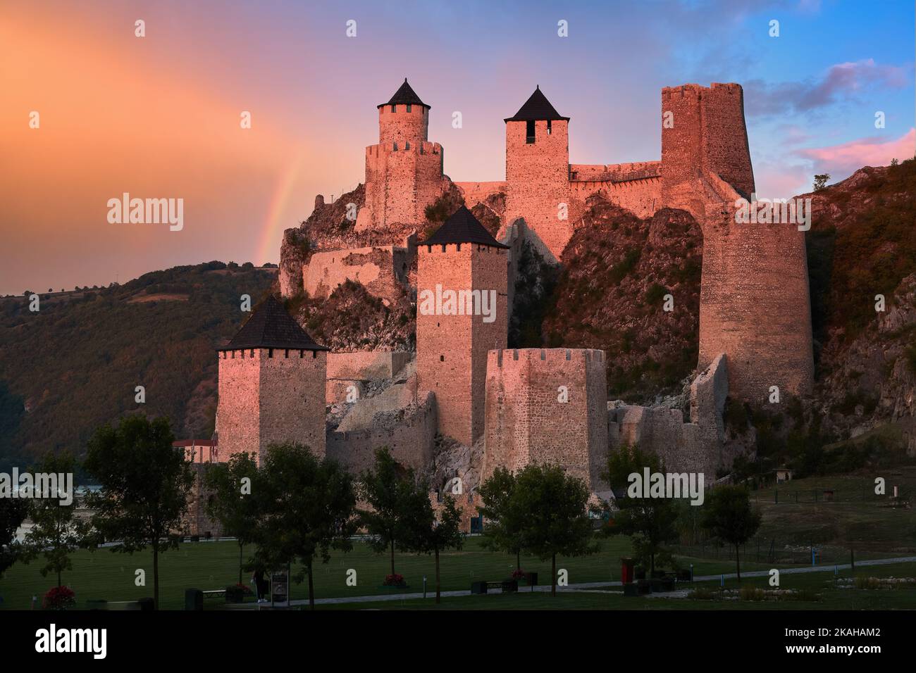 The medieval fortress of Golubac, fortress towers illuminated of pink ...