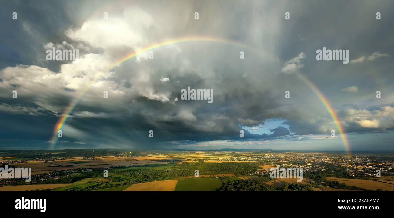 A rainbow over a farmland, the remnants of a storm, a dramatic sky ...