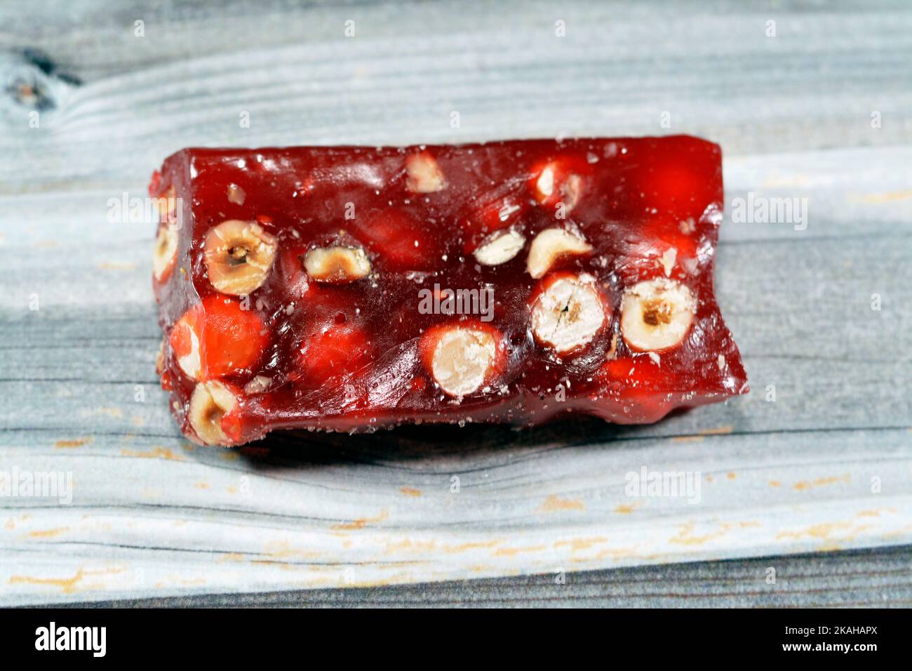 Red piece of Arabian sweet candy domeya stuffed with hazelnuts ...