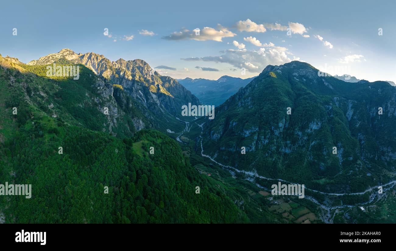 A panoramic, aerial view of the Theth valley during sunset. Hiking ...