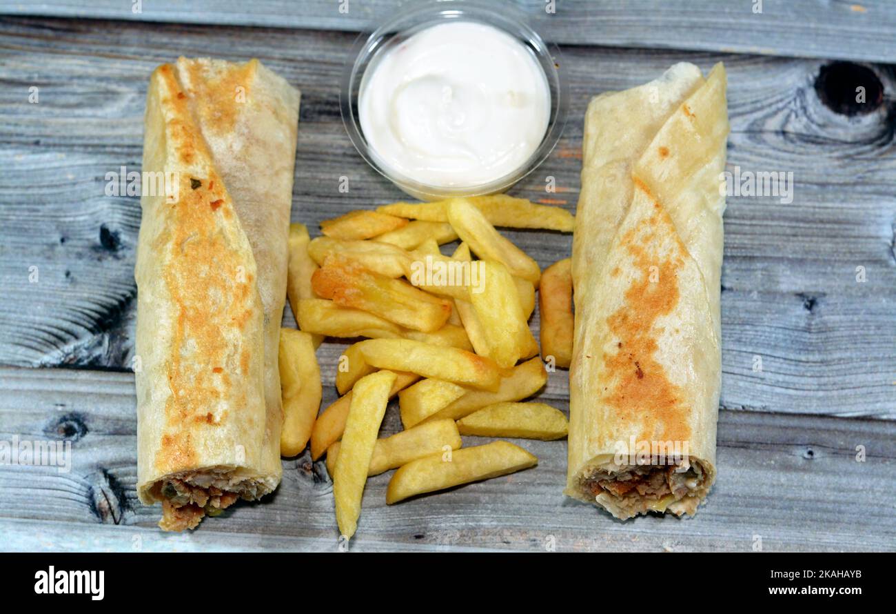 Syrian recipe cuisine background, chicken shawerma or shawarma tortilla ...