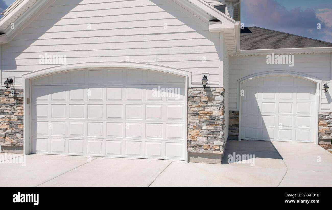 Panorama Puffy clouds at sunset Three car garage exterior with two ...