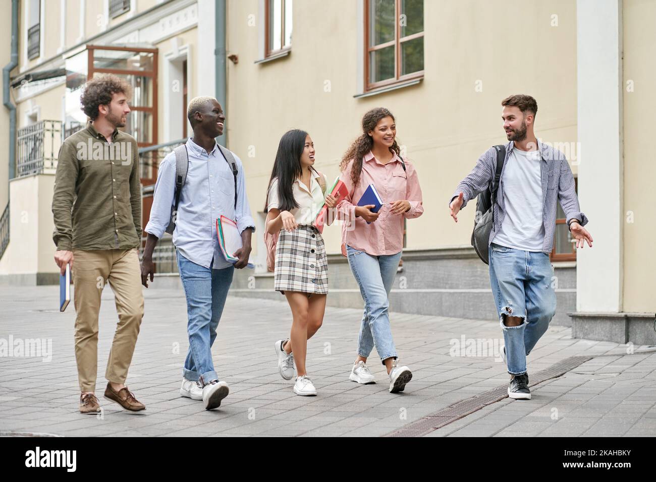 multiethnic group of students walking down a city street Stock Photo ...