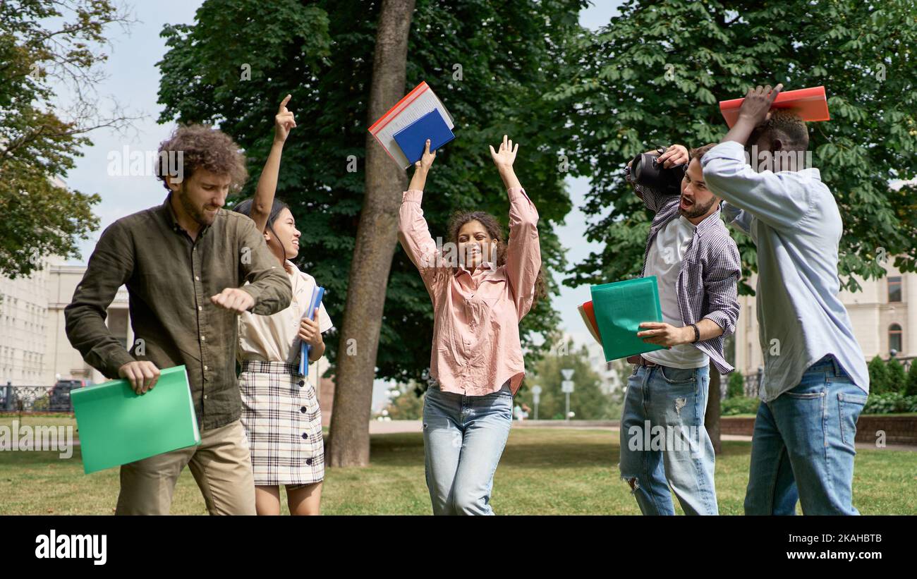 friends students dancing on the green grass Stock Photo - Alamy